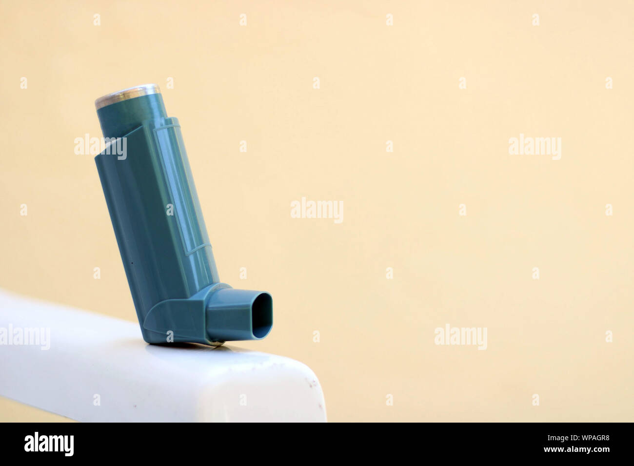 Medicine and health concept: Blue inhaler on a white background ...
