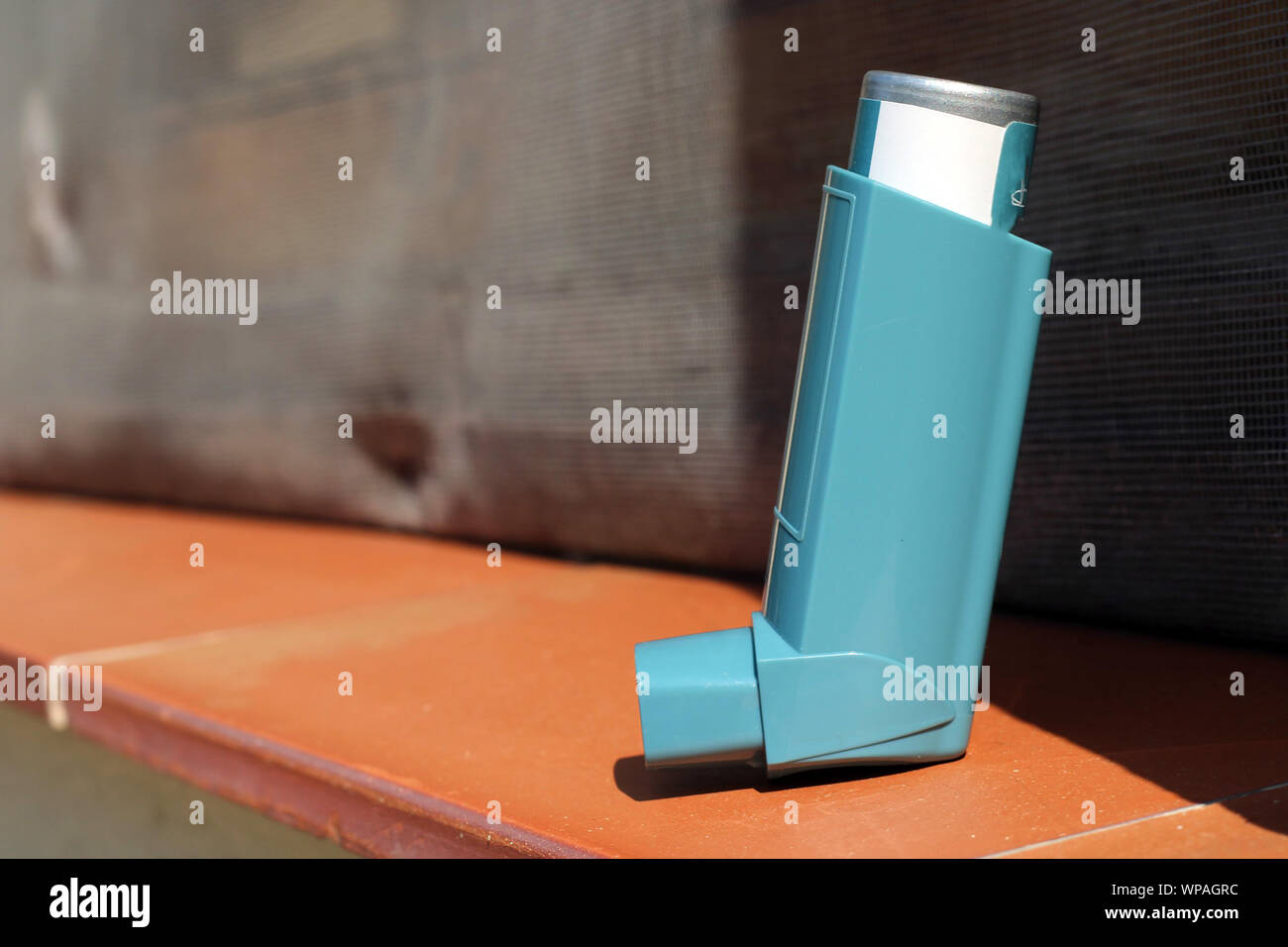 Medicine and health concept: Blue inhaler. Pharmaceutical product for ...
