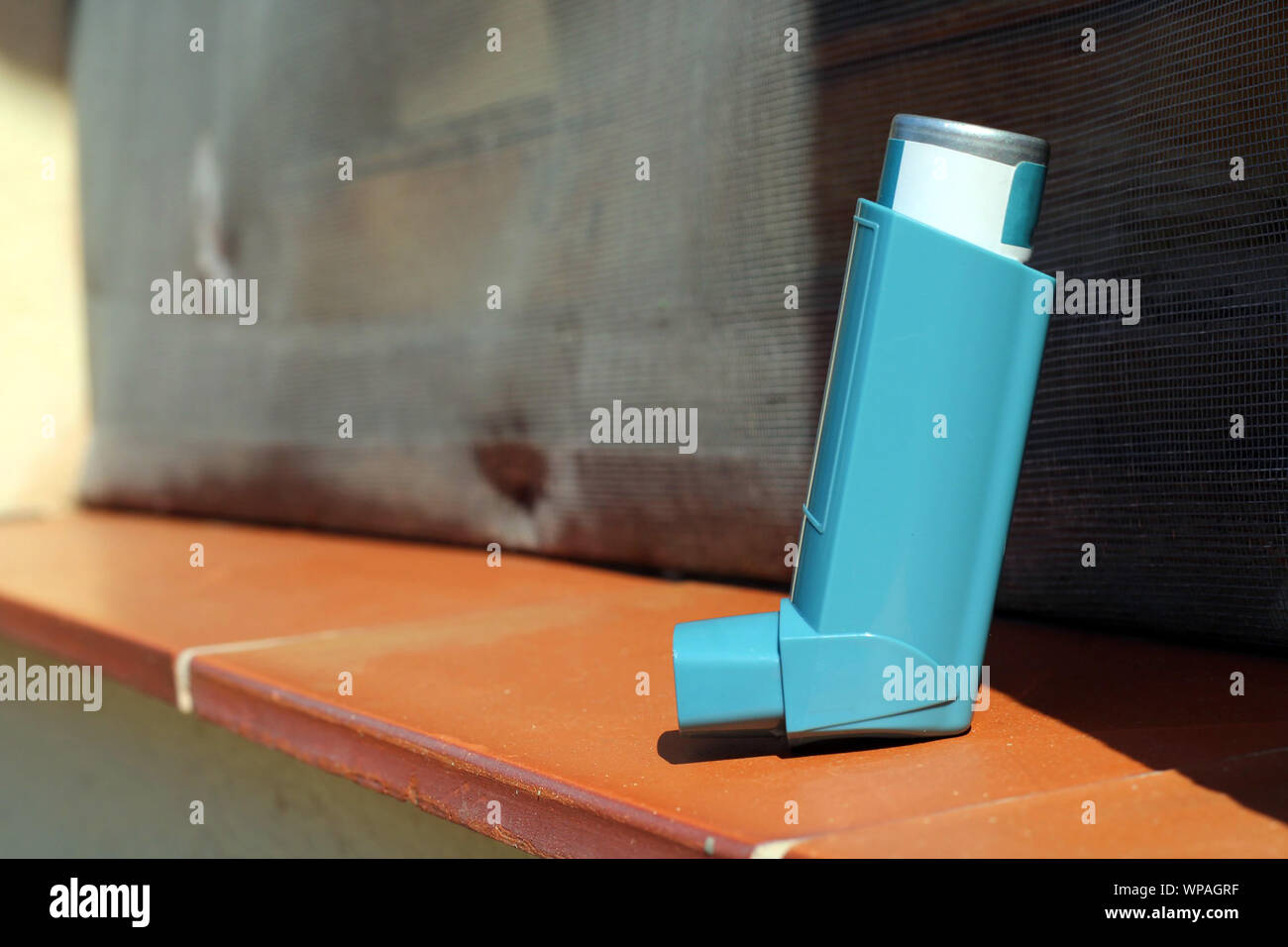 Medicine and health concept: Blue inhaler. Pharmaceutical product for ...