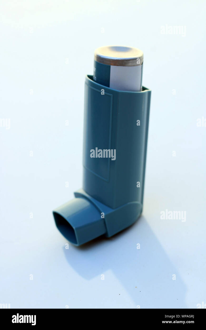Medicine and health concept: Blue inhaler on a white background ...