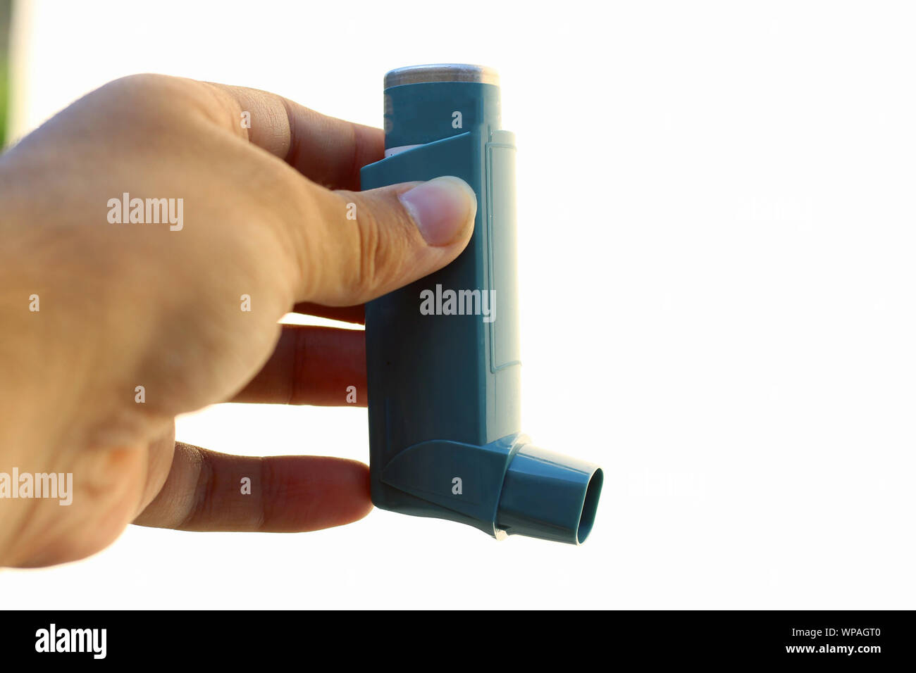 Medicine and health concept: Blue inhaler on a white background ...