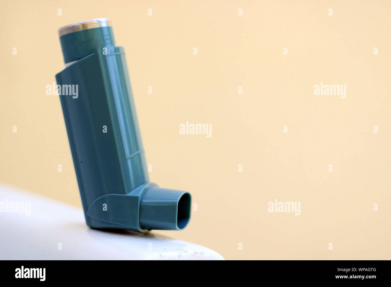 Medicine and health concept: Blue inhaler on a white background ...