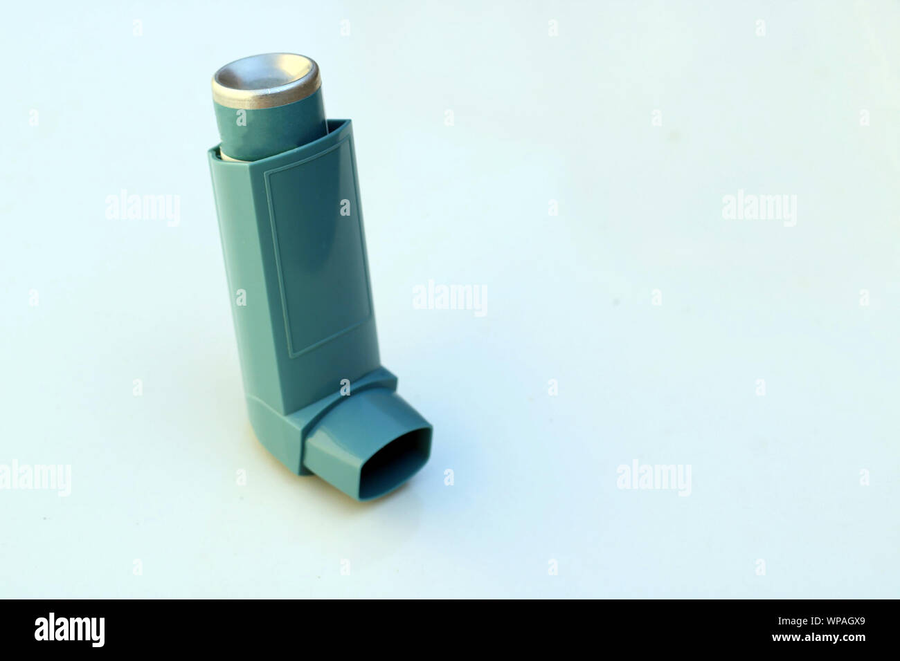 Medicine and health concept: Blue inhaler on a white background ...