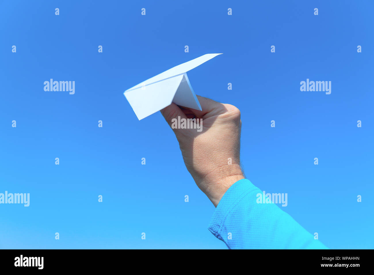 Hand with paper white airplane. A man launches a paper airplane Stock ...