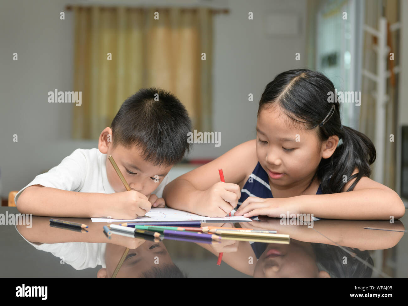 Two children are drawing together, education concept Stock Photo - Alamy