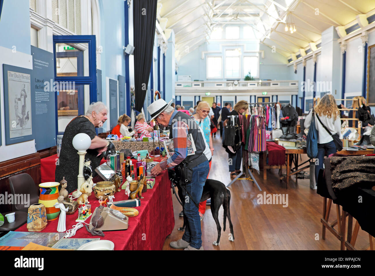 Lewes Market hall interior traders selling wares & man with dog looking ...