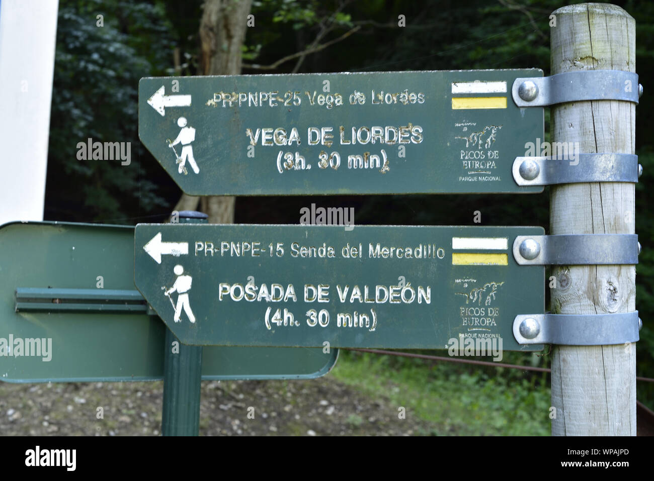 Two waymarker signs at the start of a footpath from Fuente De, Picos de ...