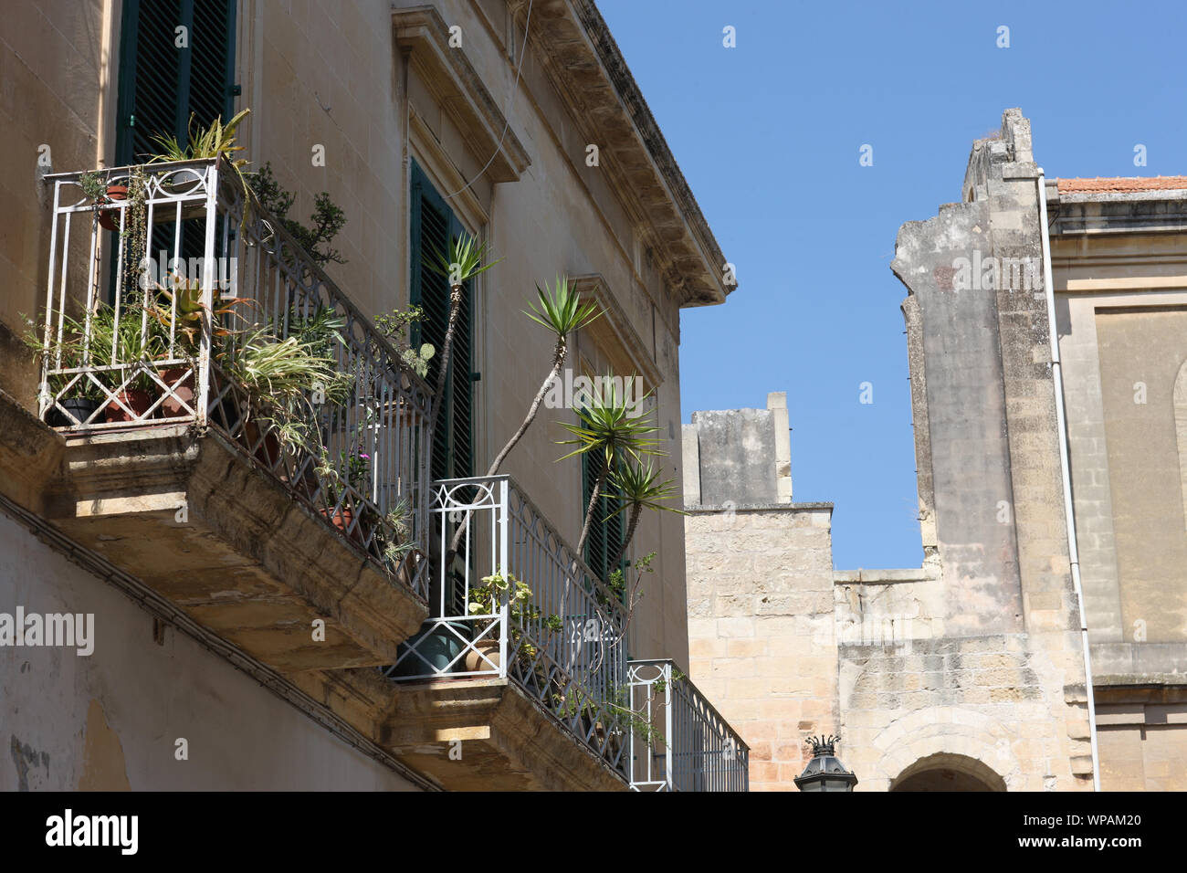 Balconies on the facade of an ancient building with houseplants Stock ...