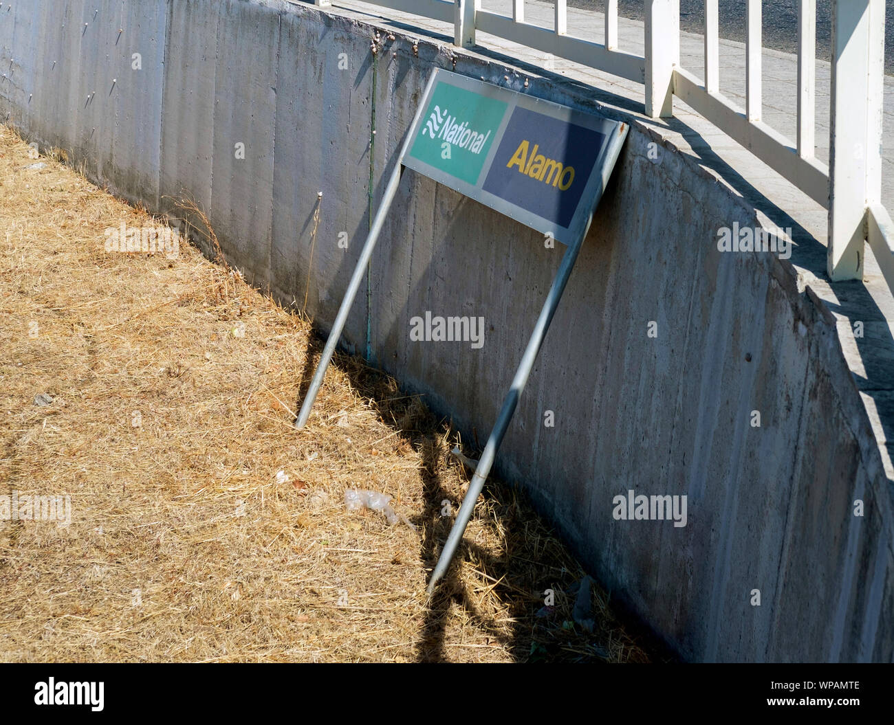 National and Alamo rent a car sign trown away in a car parking area ...