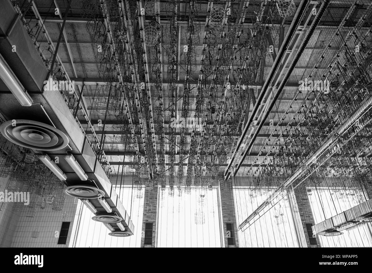 BW tone, low angle interior view of open ceiling of old abandon factory ...
