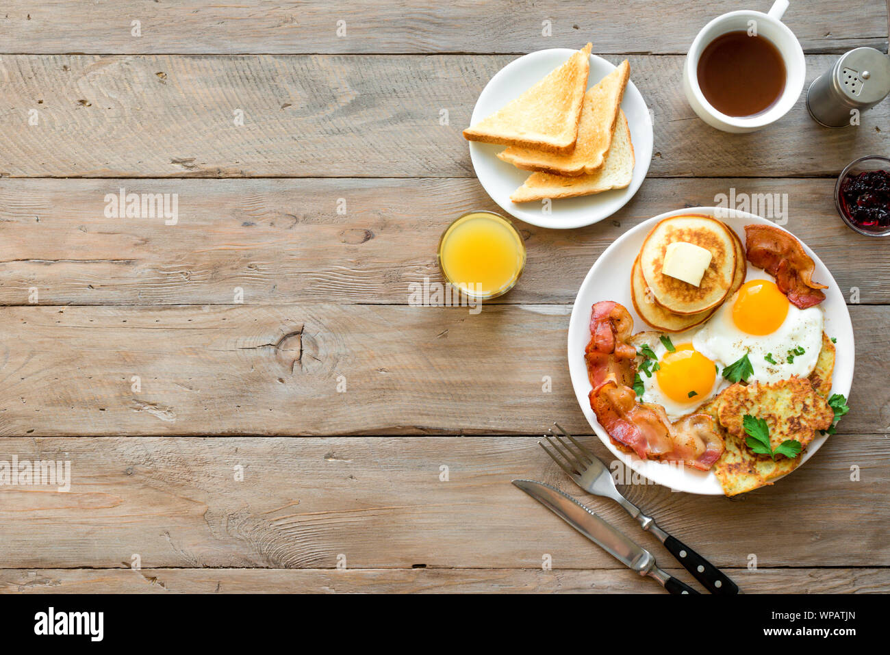 Full American Breakfast on wooden, top view, copy space. Sunny side ...