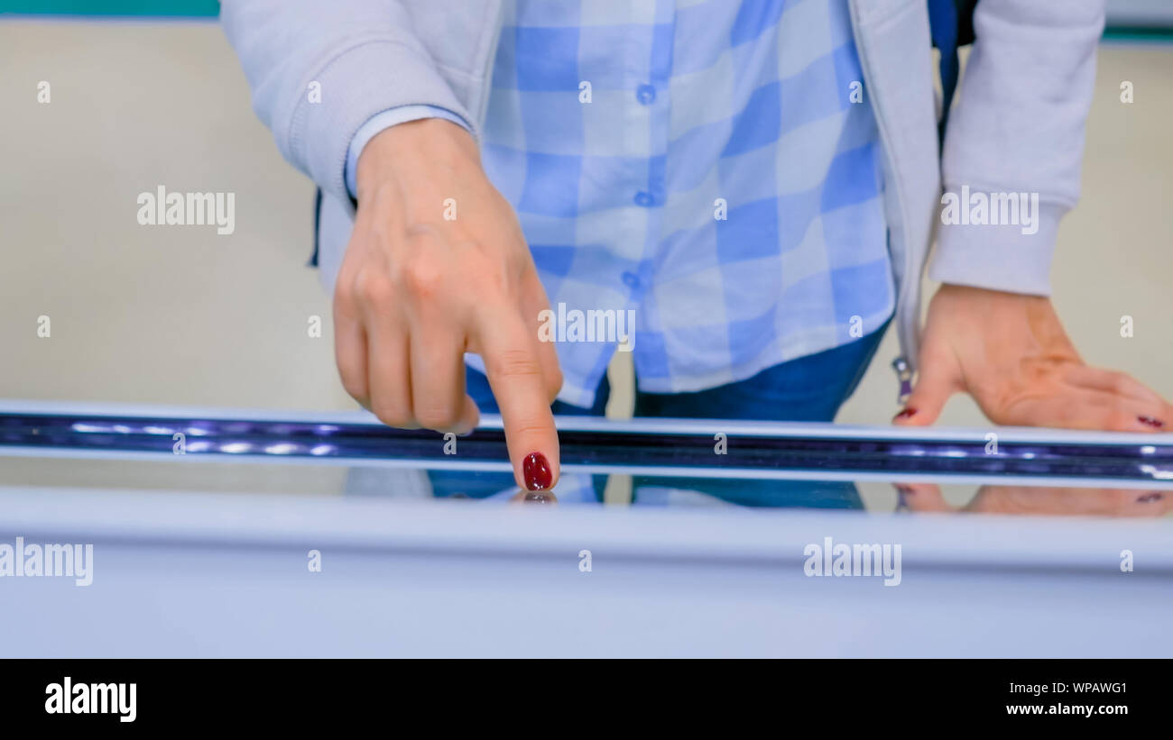 Woman using interactive touchscreen display kiosk Stock Photo - Alamy