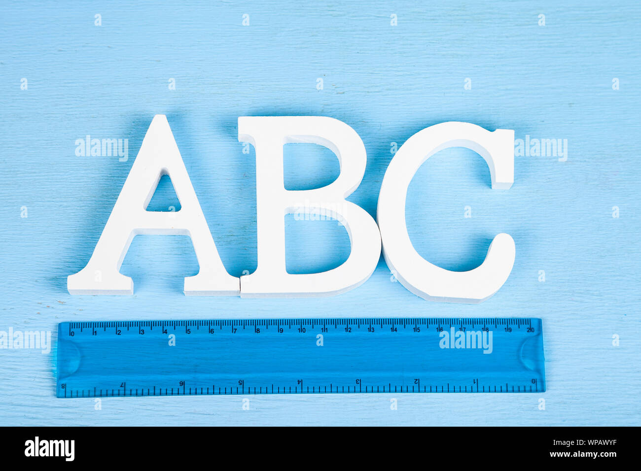Back to school. ABC letters and ruler on a blue wooden background Stock ...