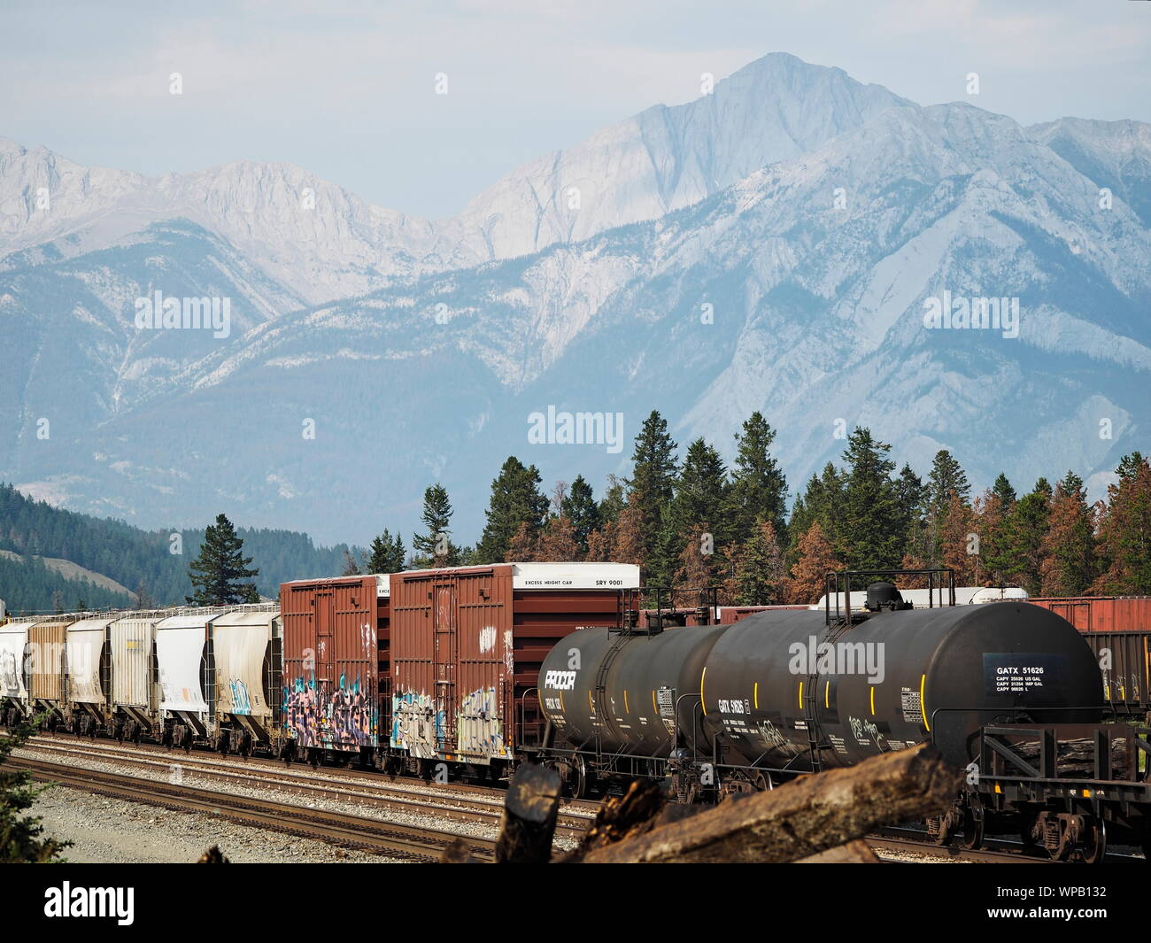 Railway train passing mountains hi-res stock photography and images - Alamy
