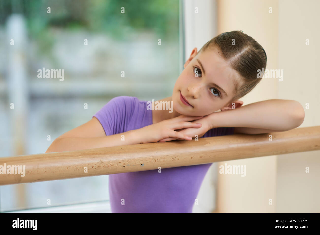 Beautiful teen ballerina resting on barre Stock Photo - Alamy