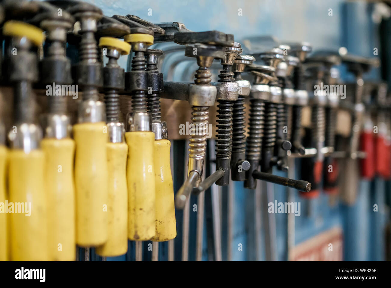 Special clamps for fastening and gluing timbers. Carpentry workspace detail Stock Photo - Alamy