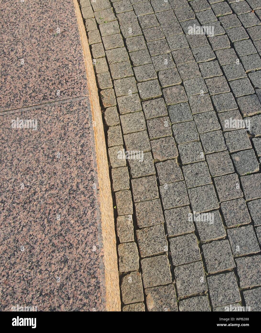 Granite paving stones laid on the road. Pavement. Background photo ...