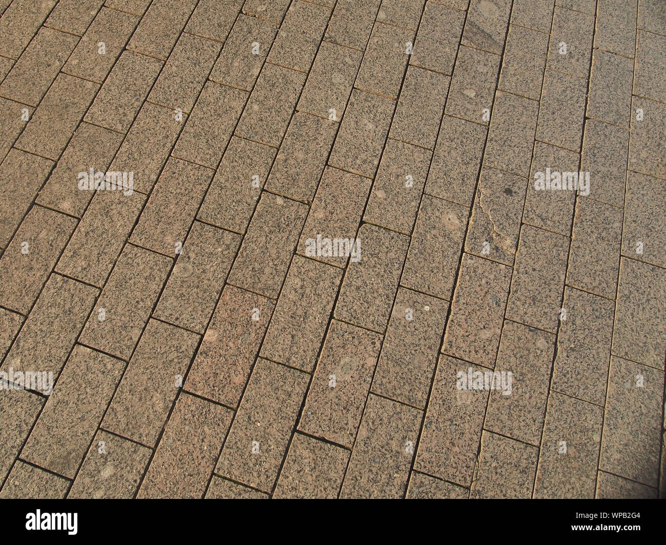 Granite paving stones laid on the road. Pavement. Background photo ...