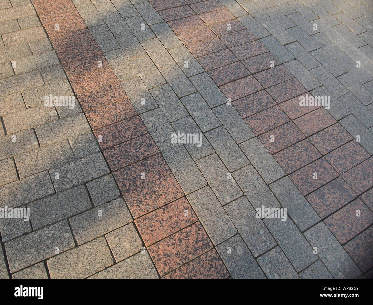 Granite paving stones laid on the road. Pavement. Background photo ...