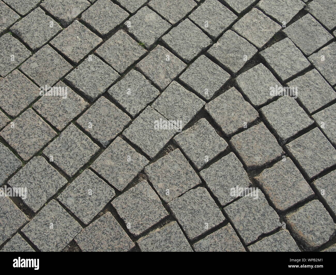 Granite paving stones laid on the road. Pavement. Background photo ...