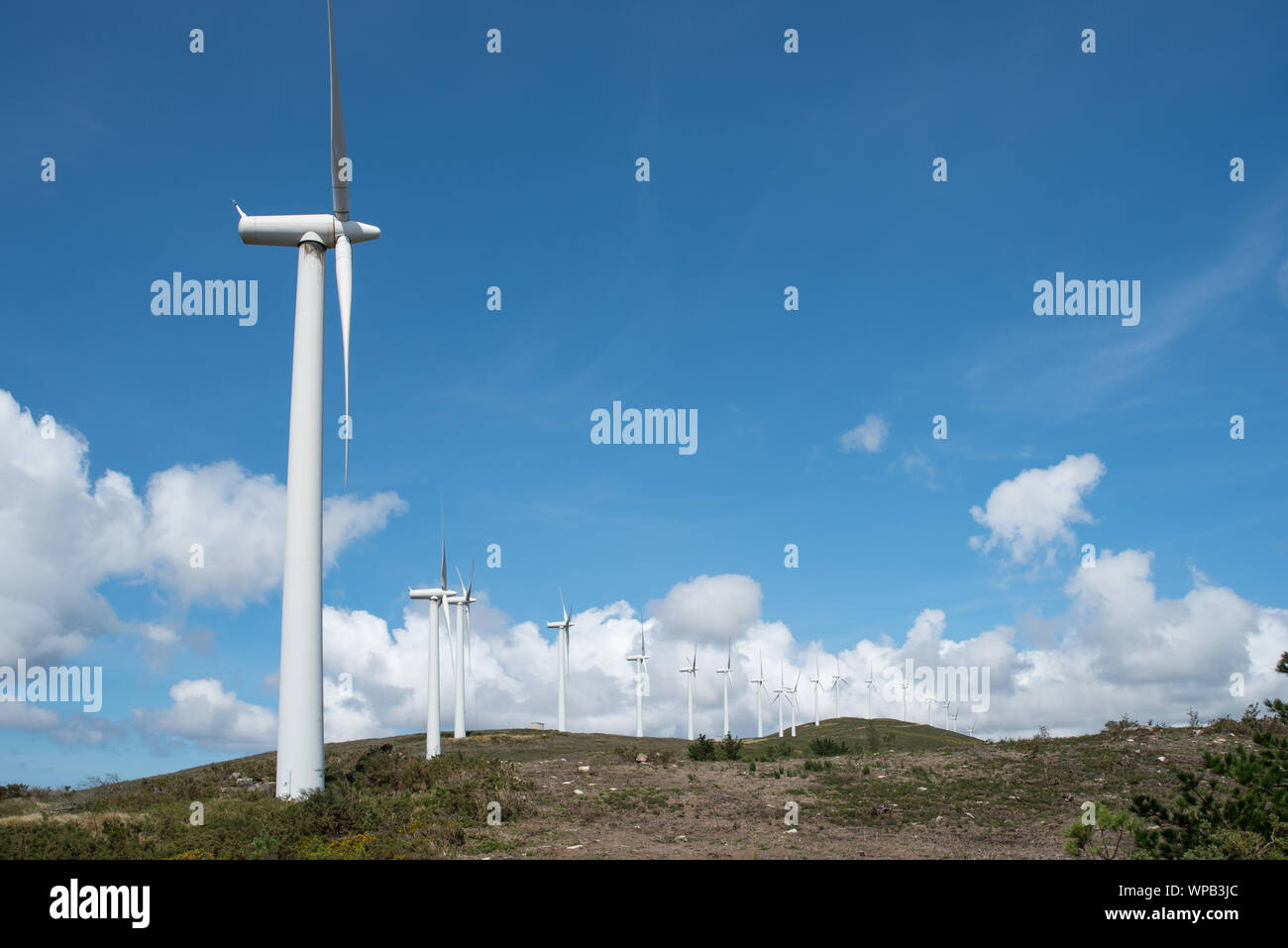 Wind power plant on hilltop in Europe Stock Photo - Alamy