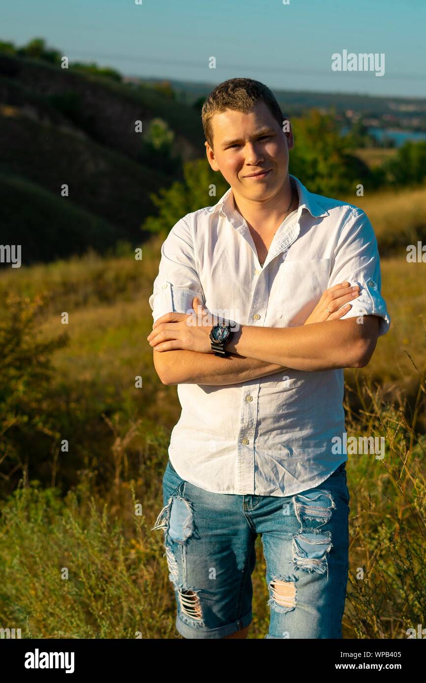 Beautiful portrait of handsome man standing in field at sunset Stock ...