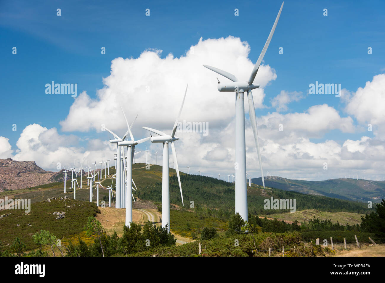 Wind power plant on hilltop in Europe Stock Photo - Alamy