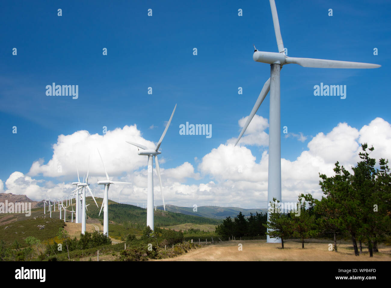 Wind power plant on hilltop in Europe Stock Photo - Alamy