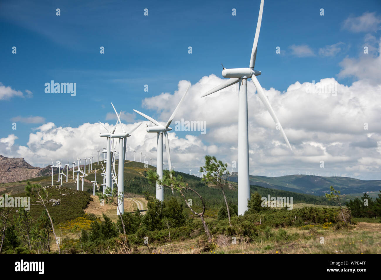 Wind power plant on hilltop in Europe Stock Photo - Alamy