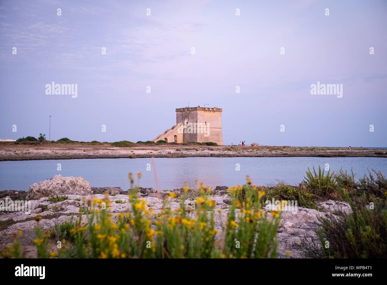 View of the ancient defensive coastal tower Torre Lapillo at the sunset ...