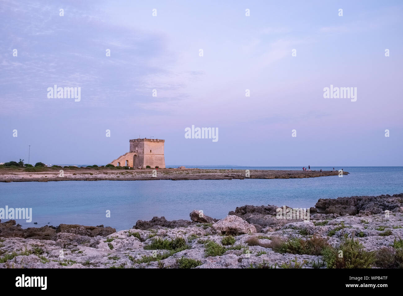 View of the ancient defensive coastal tower Torre Lapillo at the sunset ...
