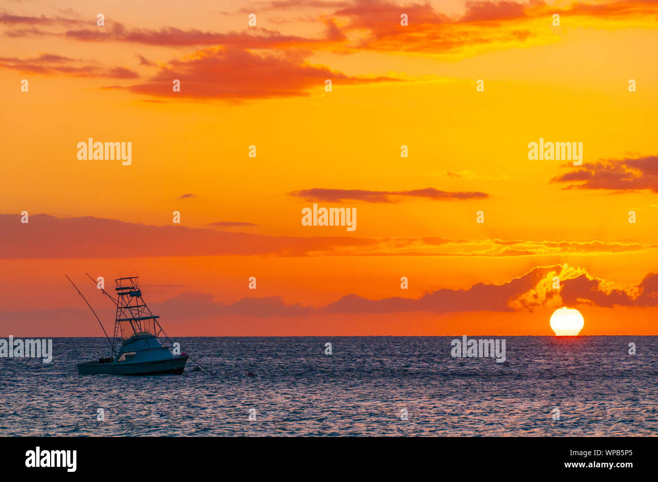 Beautiful sunset behind sport fishing boat with a flying bridge on Maui ...