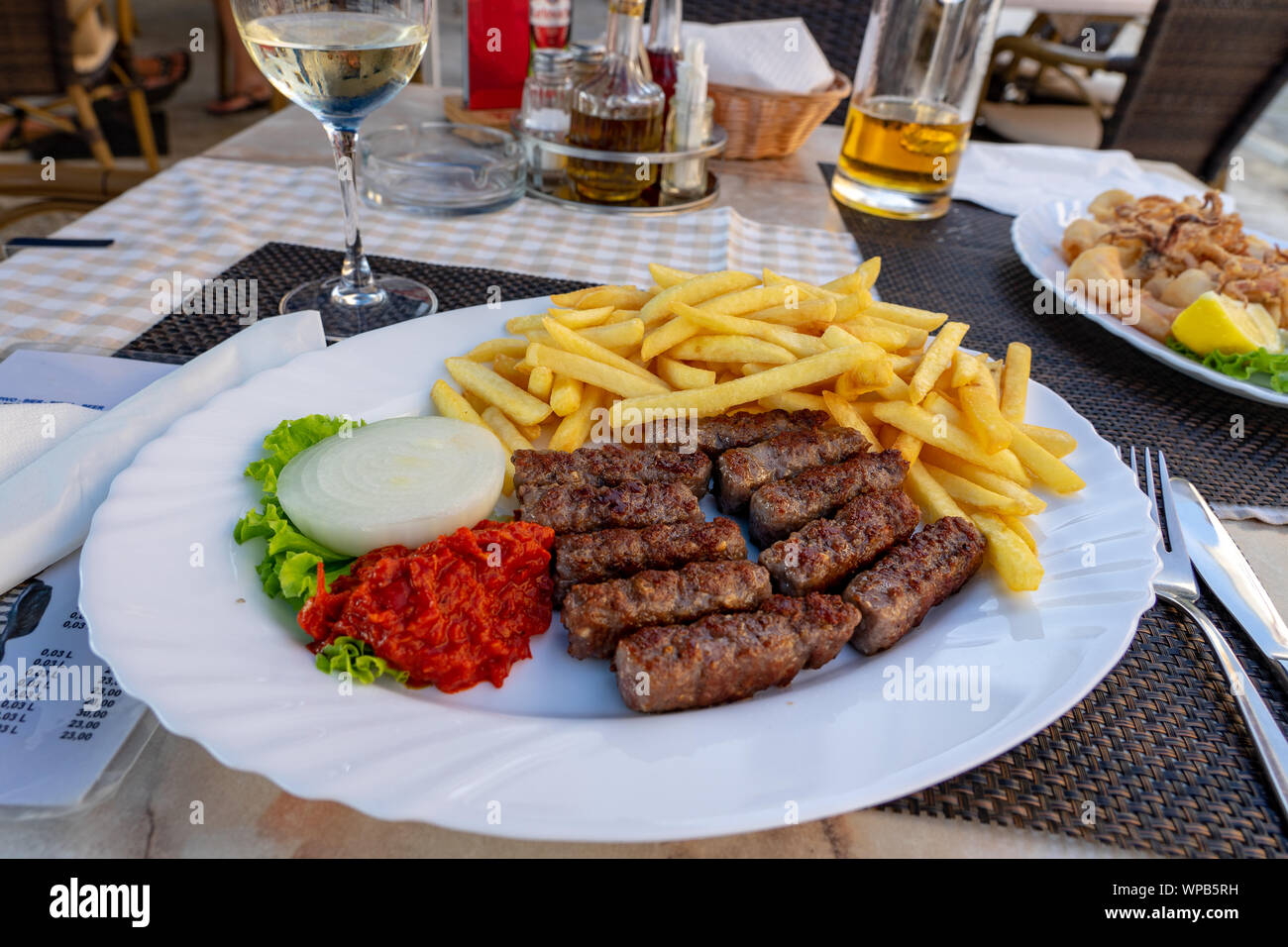 traditional croatian balkan cevapcici dinner with fies ajvar and onion ...