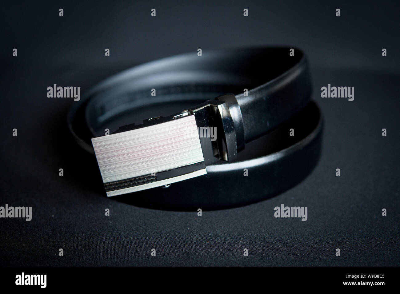 detail of men's black belt isolated over black background Stock Photo ...