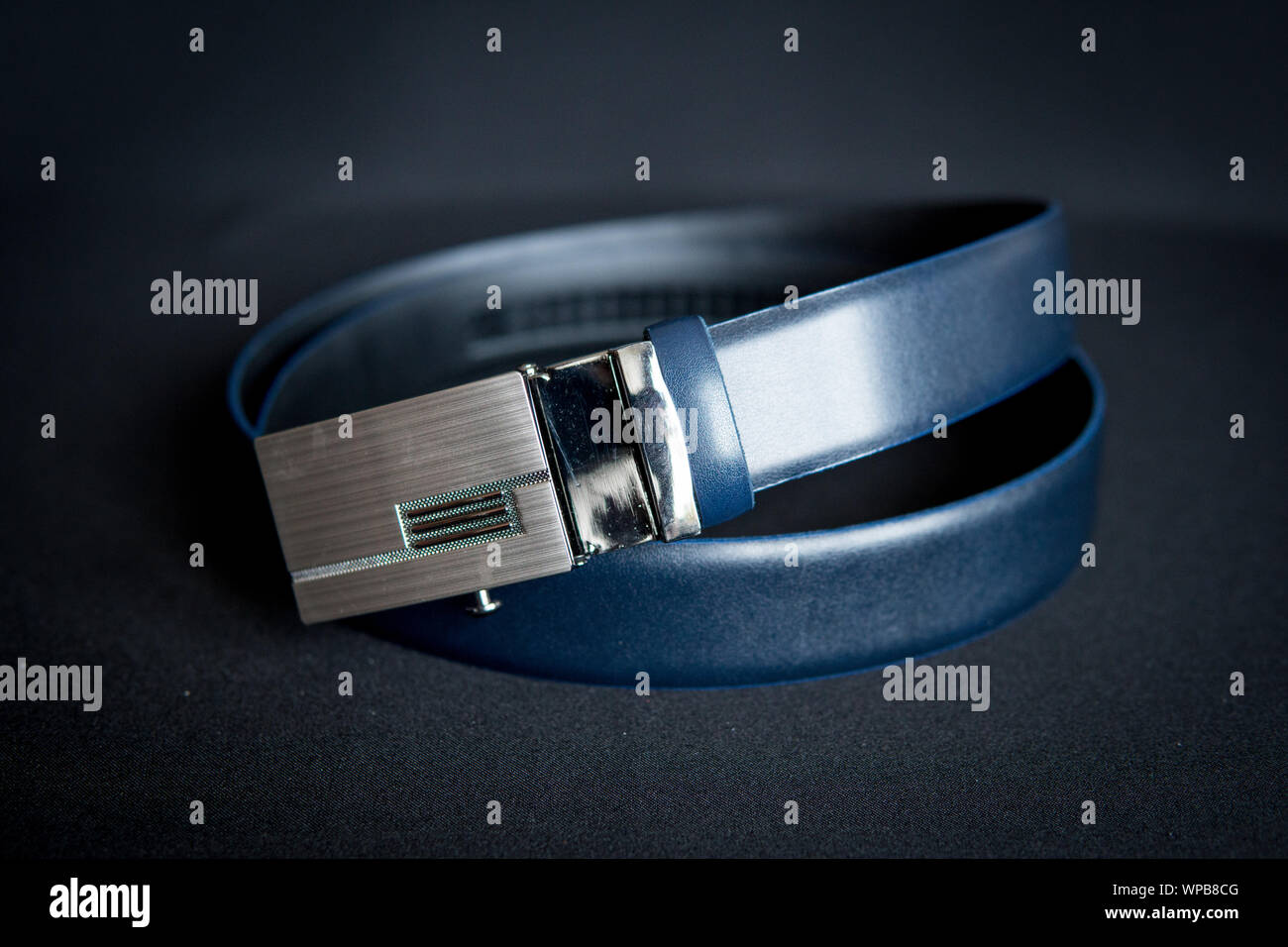 detail of blue belt isolated over black background Stock Photo - Alamy