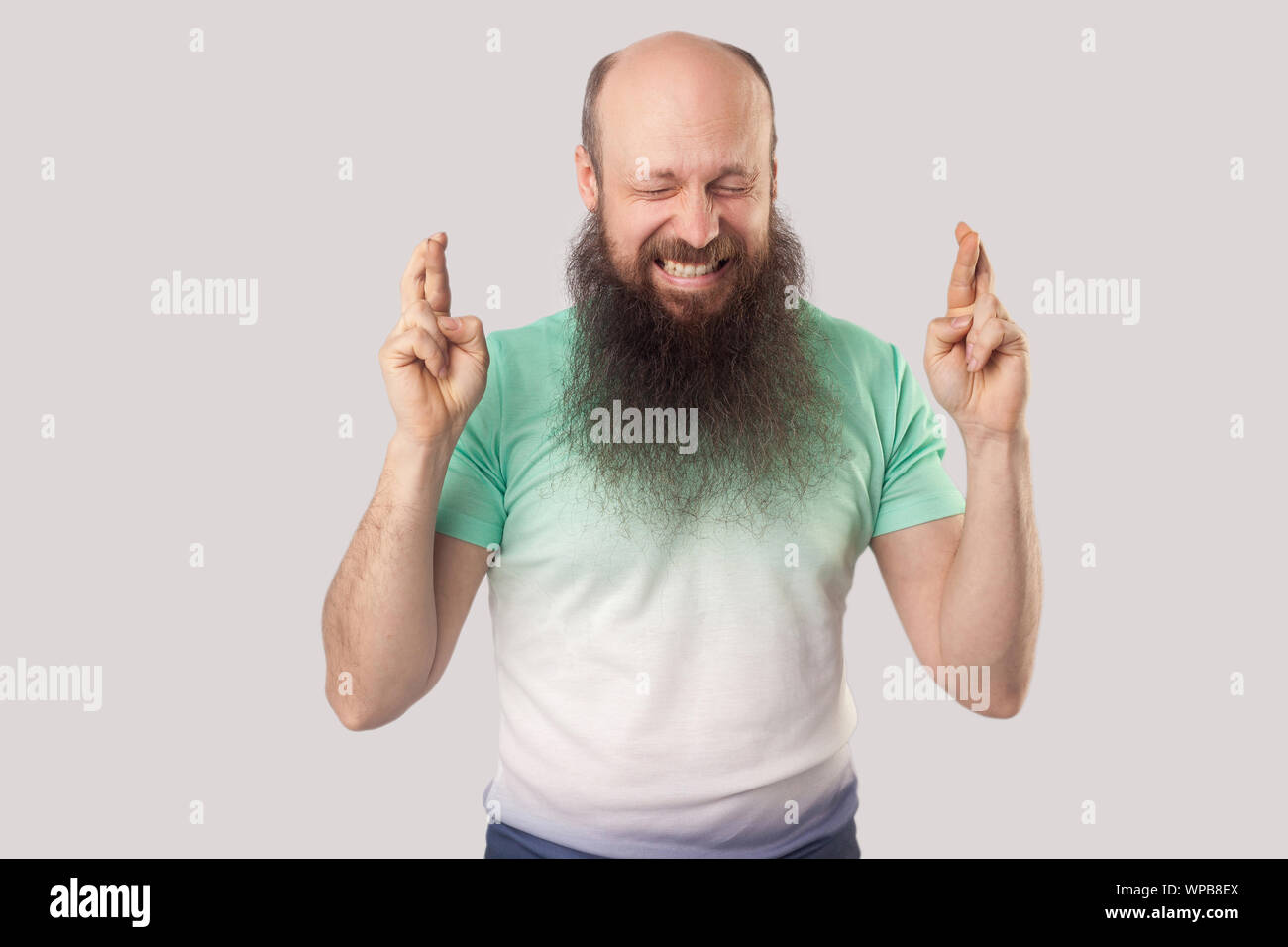 Portrait of hopeful middle aged bald bearded man in green t-shirt ...