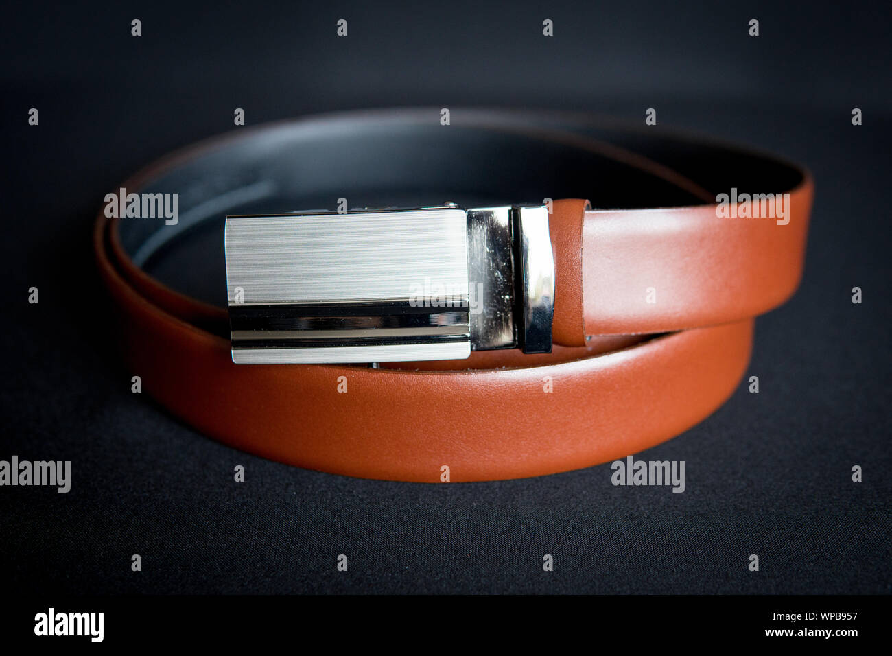 detail of a men's brown belt isolated over black background Stock Photo ...