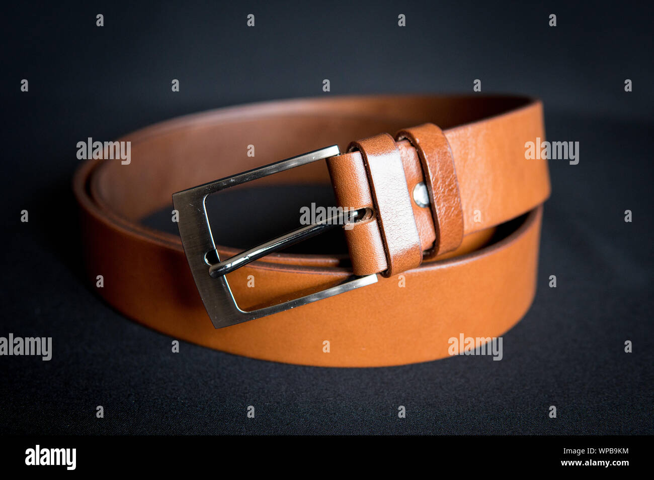 detail of a men's brown belt isolated over black background Stock Photo ...