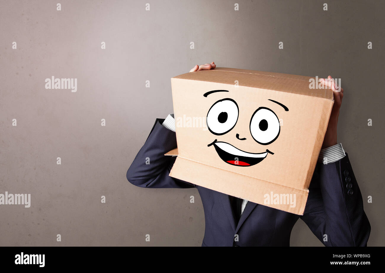 Young boy standing and gesturing with a cardboard box on his head Stock ...