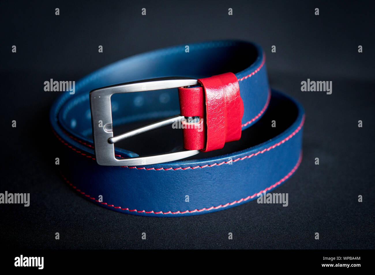 detail of blue belt isolated over black background Stock Photo - Alamy