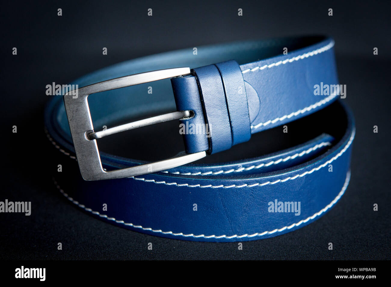 detail of blue belt isolated over black background Stock Photo - Alamy