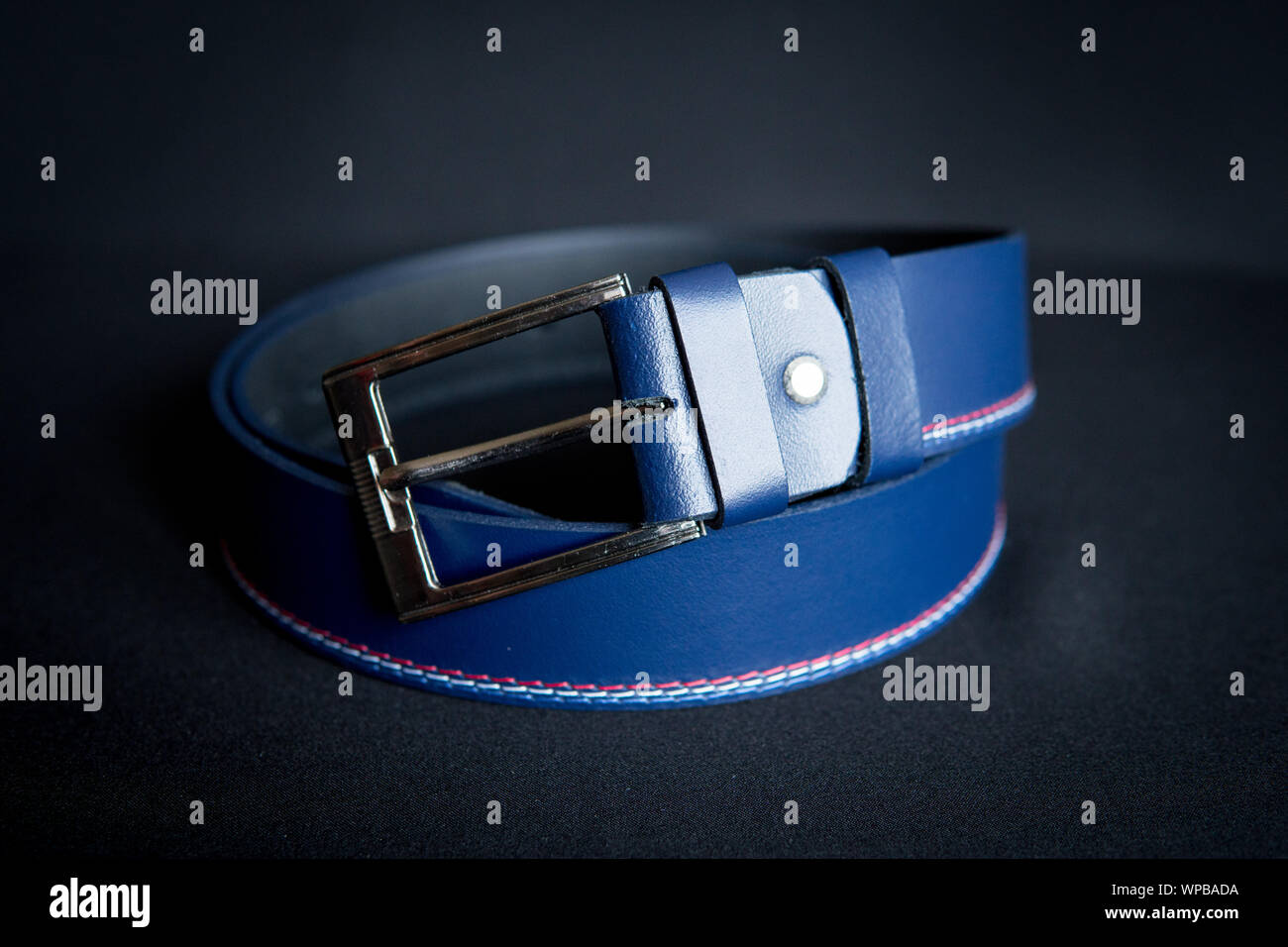 detail of blue belt isolated over black background Stock Photo - Alamy