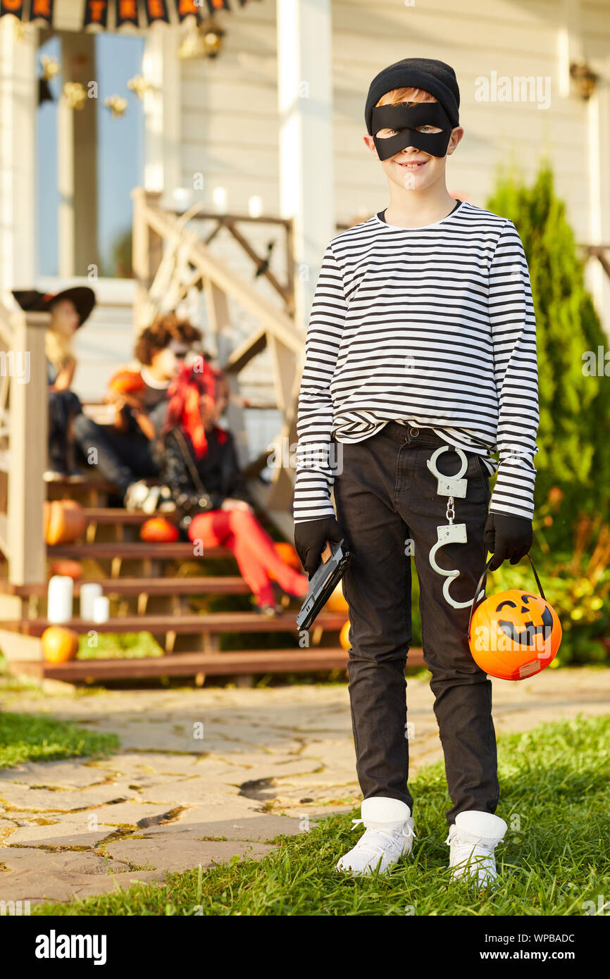 Full length portrait of cute teenage boy dressed as bandit posing ...