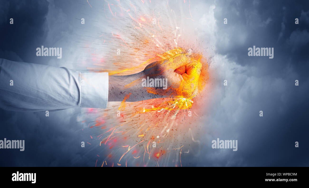 Hand hits strongly and makes fire beam around Stock Photo - Alamy