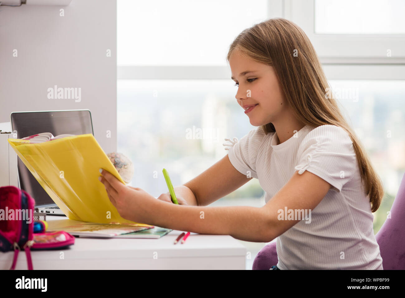 School girl study homework with books and writing. Home interior Stock ...