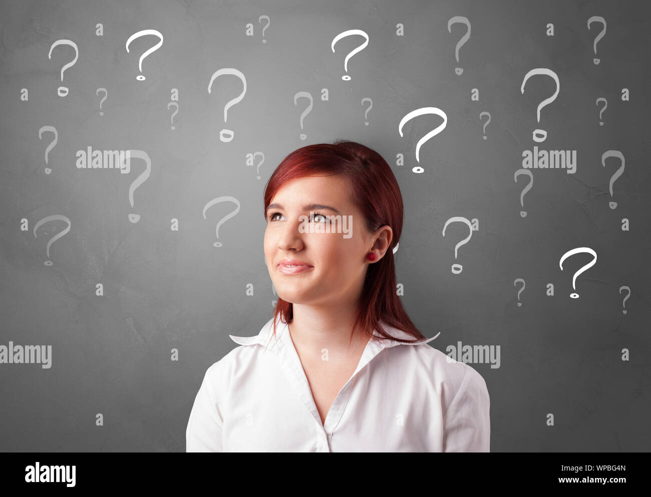Person with question marks around face Stock Photo - Alamy