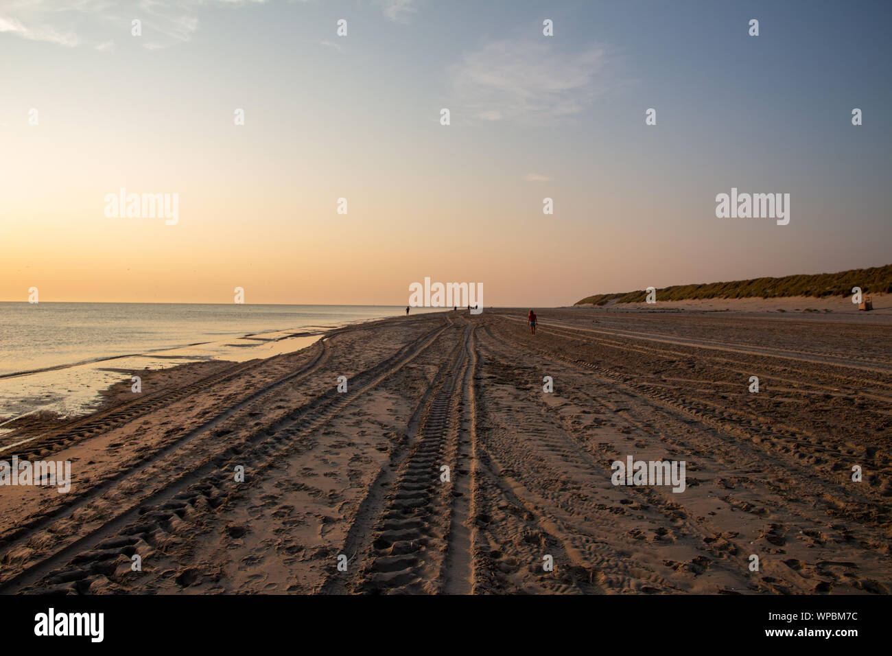 A beautiful sunset at the beach of Ameland, Friesland, North Sea white ...