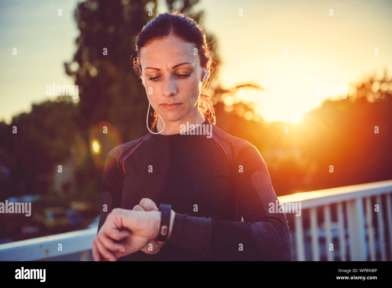Woman monitoring her progress on smart watch Stock Photo - Alamy