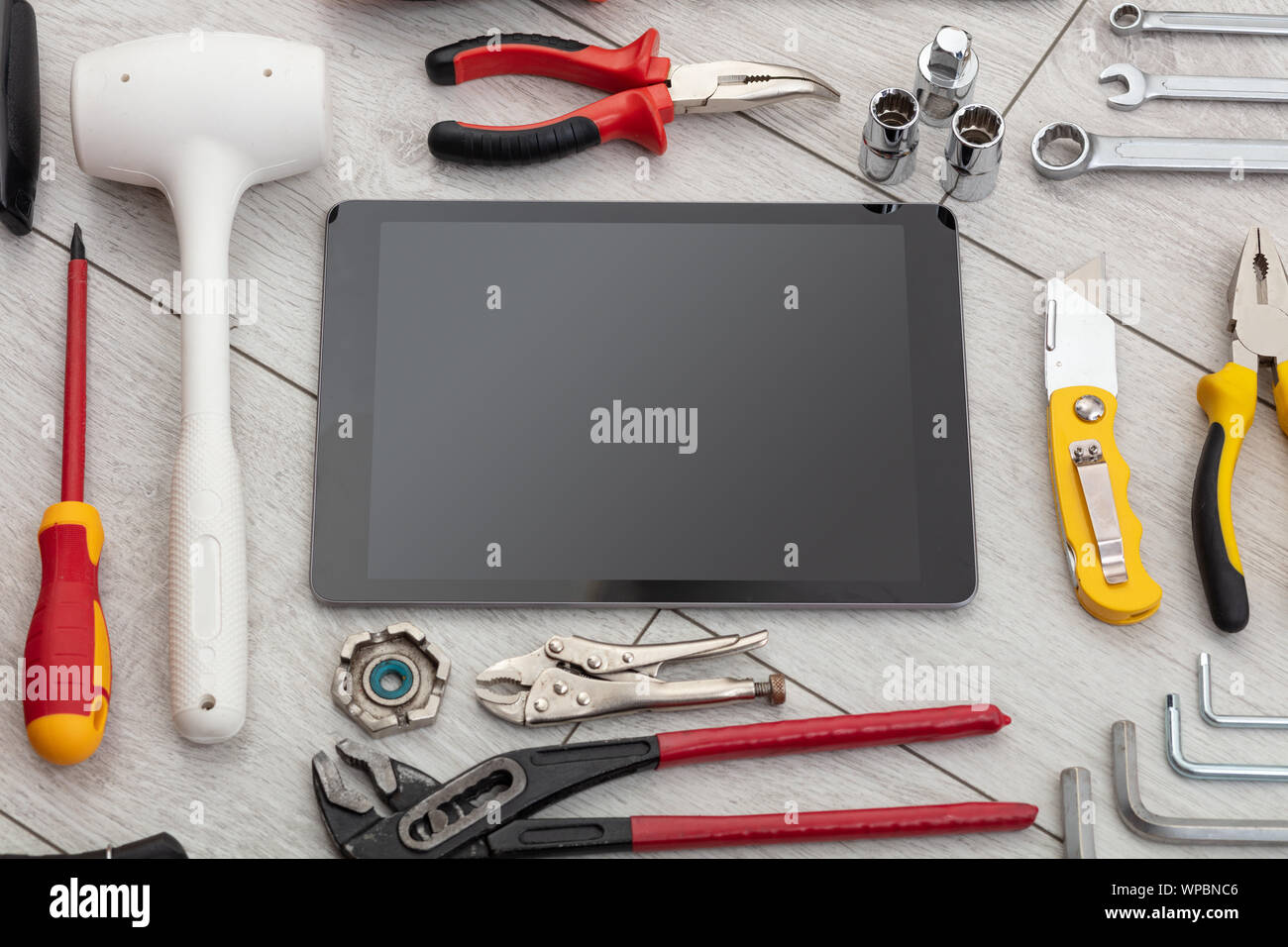 Tablet with empty screen and construction tools around Stock Photo - Alamy