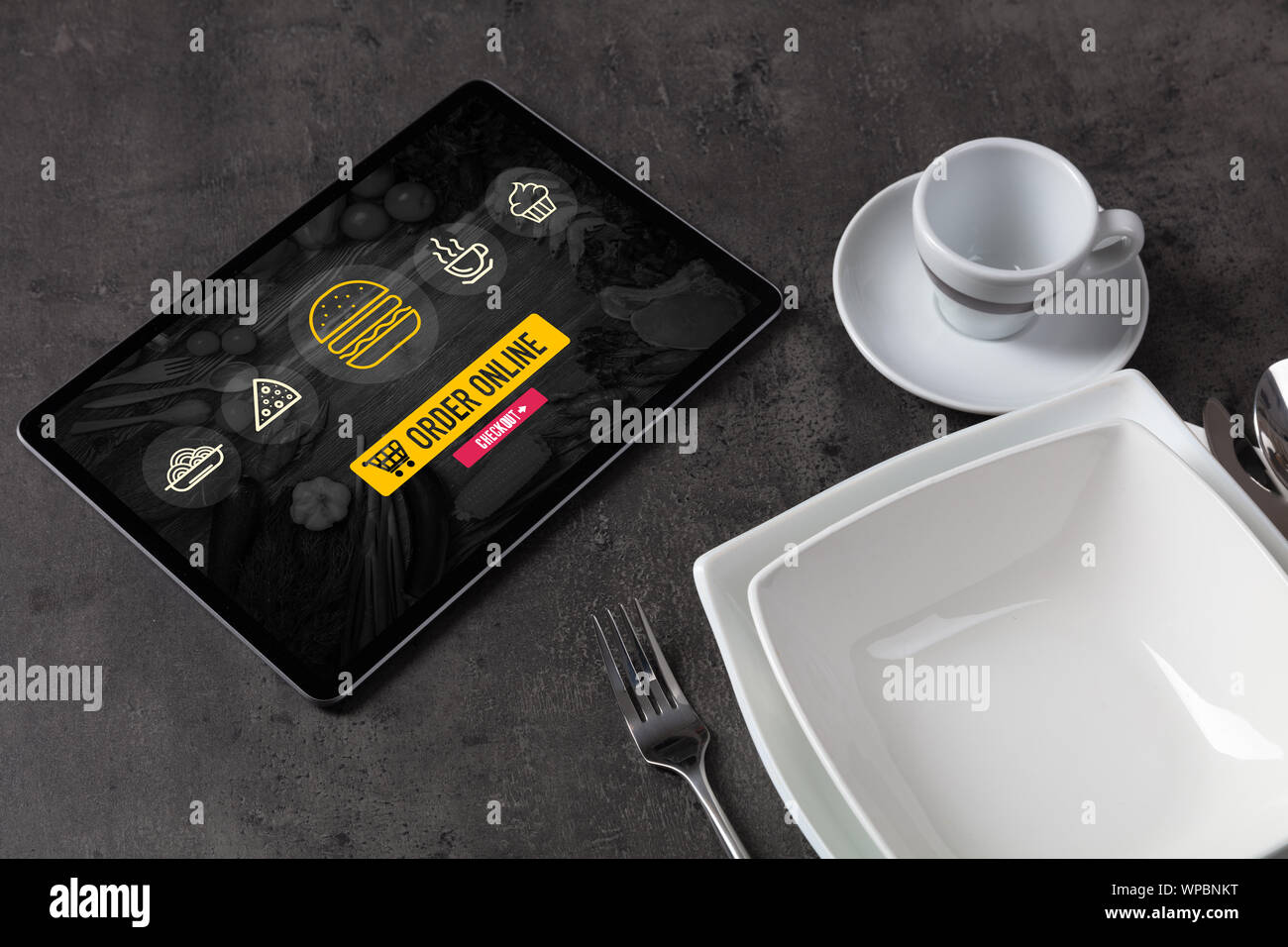 Online fast food order concept on a laid table Stock Photo - Alamy